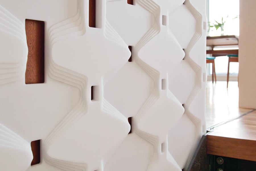 A laminated plexiglass screen along the stairs makes this entry hall ...